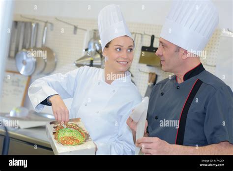 Male And Female Chefs Working At Kitchen Stock Photo Alamy