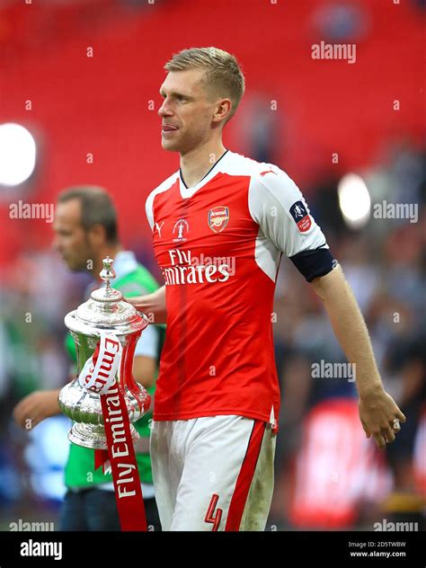 Arsenals Per Mertesacker Celebrates On The Pitch After His Side Win