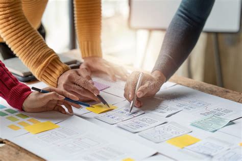 Group Of Ux Developer And Ui Designer Brainstorming About App Interface