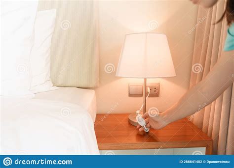 woman hand turning on or turning off switch the minimal lamp in modern