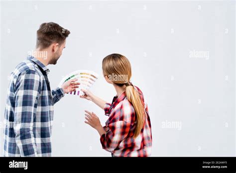 Back View Of Young Couple With Palette Selecting Color Of Wall Isolated