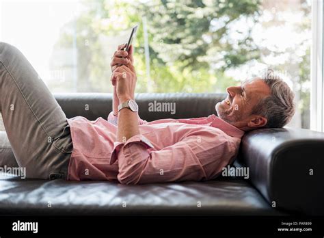 Man Lying On A Couch Hi Res Stock Photography And Images Alamy