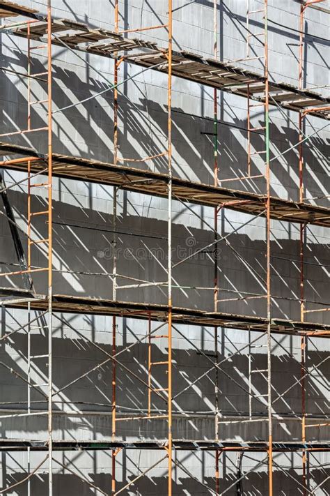 Building Facade With Scaffolding Under Renovation In Sunlight Stock