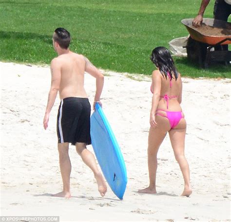 Selena Gomez flaunts her slender curves and ample cleavage in a skimpy pink bikini as she lets ...