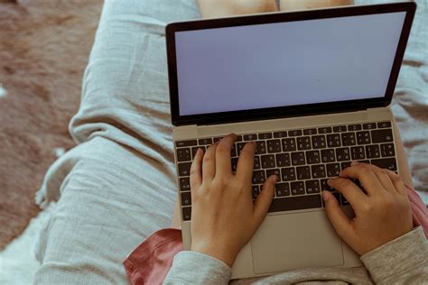 Crop Anonymous Female Freelancer Typing On Laptop With Blank Screen