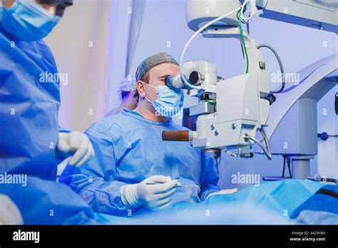 Man Under A Surgical Microscope For Vision Correction Eye Surgery A Patient And A Surgeon In