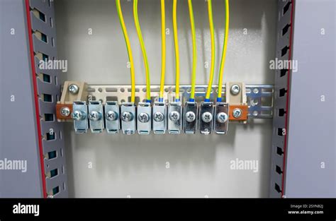 Grounding Terminal Block With Connected Yellow Wires Inside An Industrial Electrical Panel Stock