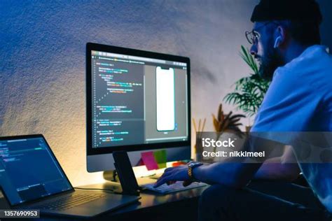 Young Man Mobile Developer Writes Program Code On A Computer Programmer