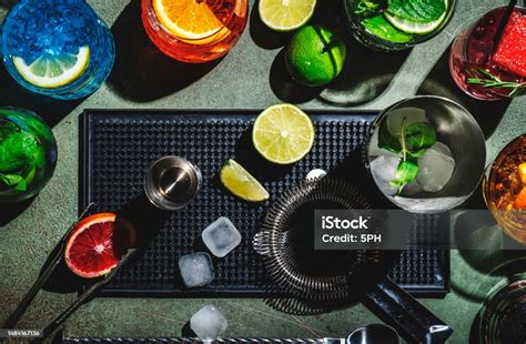 녹슨 녹색 바 카운터에 칵테일이 놓여 있습니다 믹솔로지 개념입니다 여름 칵테일 파티를 위한 다채로운 독알코올 음료와 저알코올 음료 모음 어두운 배경 바 도구 하드 라이트 0