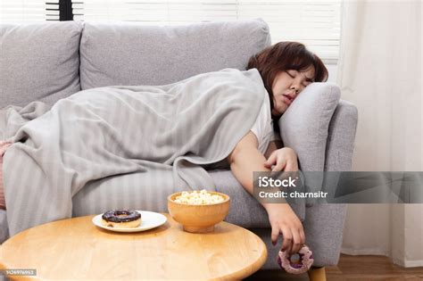 Lazy Overweight Woman Sleep On The Couch With Doughnut In Her Hand Stock Photo - Download Image ...