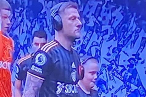 Leeds Captain Liam Cooper Wears Noise Cancelling Headphones With Mascot