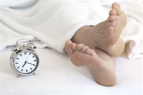 Naked Feet In Bed With Alarm Clock Stock Image Image Of Sole Foot