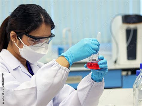 The Scientist Wears Ppe And Holds An Erlenmeyer Flask Laboratory With