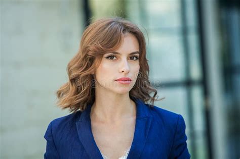 Portrait Of A Beautiful Young Woman With Long Brown Hair Smiling At The