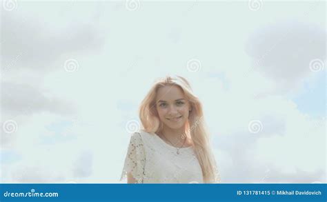 Young Russian Girl Blonde Posing Against A White Sky On A Summer Day