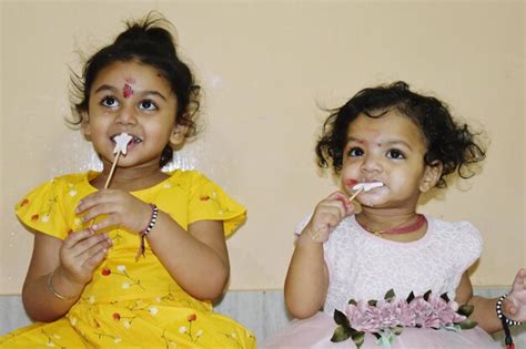Premium Photo Portrait Of Smiling Girl Who Eats Sweet Candy