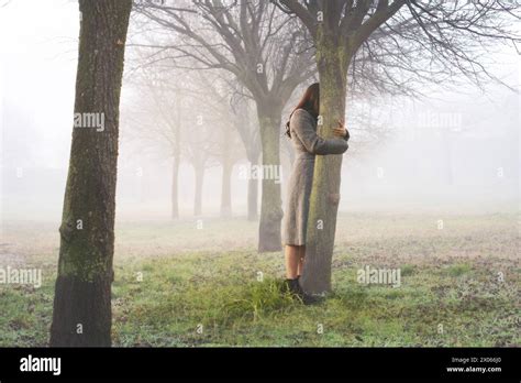 Woman Embraces With Love The Trunk Of A Tree Symbol Of Life Abstract Concept Stock Photo Alamy
