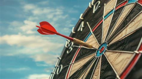 Premium Photo Red Dart Arrow Hit In The Target Center Of Dartboard With Sky Background