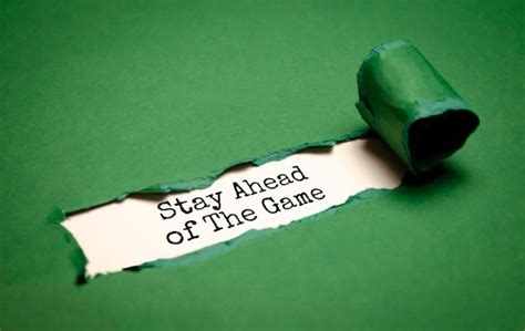 Premium Photo The Text Stay Ahead Of The Game Appearing Behind Torn