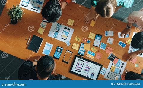 Top View Of Software Developer Team Looking Ux Design From Tablet