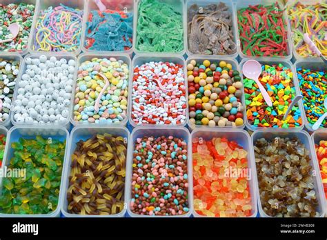 Colorful Array Of Assorted Gummy Candies Presented In Containers