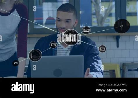 Node Appearing Above Laptop Screen Causing Chart Icons Forming Web As Colleagues Collaborating