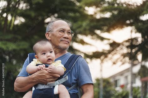 Portrait Of Happy Smiling Asian Grandfather Carrying His Cute Little