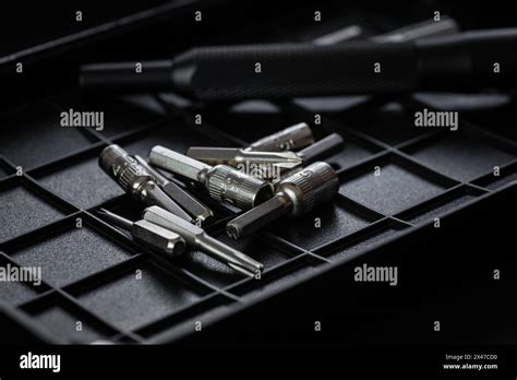 Torx Drive Bit And Aluminum Bit Driver On Black Sorting Tray Screws