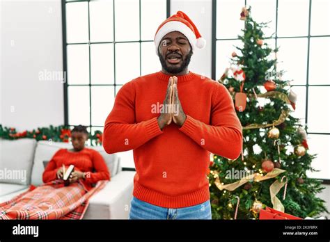 Young African American Man Standing By Christmas Tree Begging And