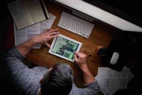 Coding Through The Night High Angle Shot Of An Unidentifiable Computer Programmer Working Alone