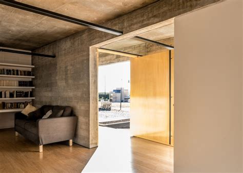 House By Tectum Features Raw Concrete Walls And Black Metal