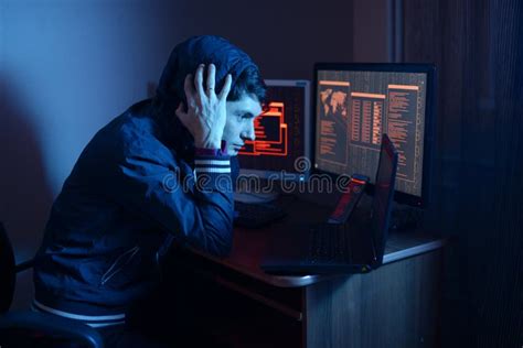 hacker in a hood thinking about the problem of hacking or malware