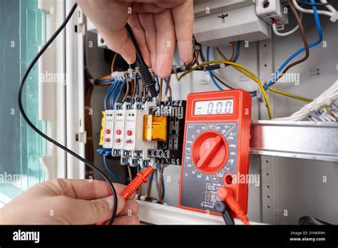 Technician Holding Probes For Circuit Testing With Multimeter Stock