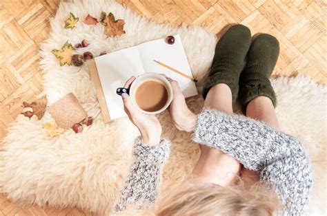 Premium Photo Woman Having Coffee While Sitting On Rug