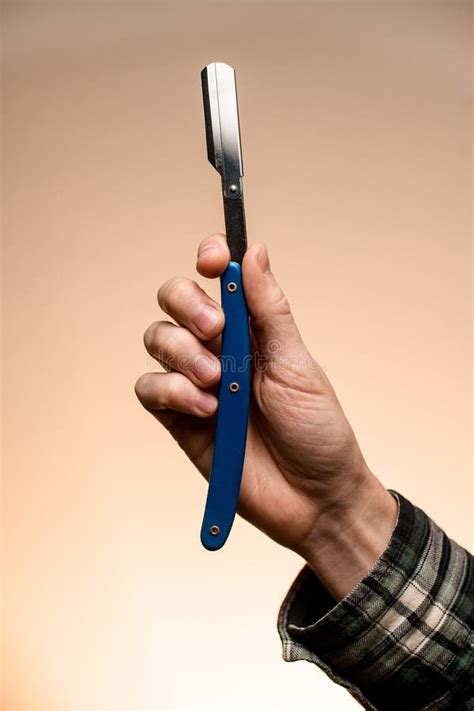 Male Hand Carefully Holding A Classic Old Fashioned Sharp Straight