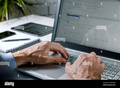 Programmer Writing Code On Laptop Computer In Office Website