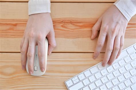 Premium Photo Female Hands With Computer Mouse And Keyboard On Wooden Table