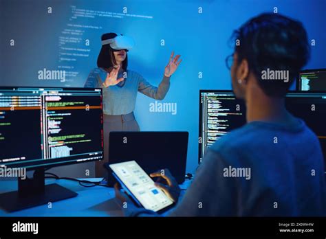 Asian And Indian Developer Devops Team Testing Virtual Reality Coding