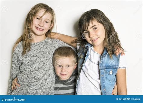 Sisters And Brother Using Tablet At Home Different Age Siblings Sitting On Sofa Using Portable