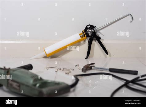 White Silicone Sealant Cartridge And Yellow Black Sealant Gun Stock