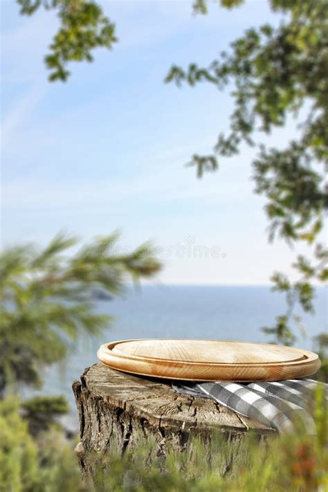 Wooden Round Plate With A Wooden Round Tree Trunk Table And Sea And Sky