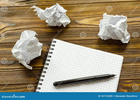 Notepad Pen And Crumpled Sheets Of Paper On Wooden Table Lack Of Idea