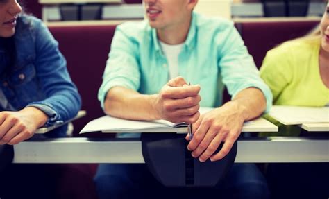 Premium Photo Group Of Students With Notebooks In Lecture Hall