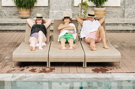 Premium Photo Father Mother And Son Covering Faces With Hat When