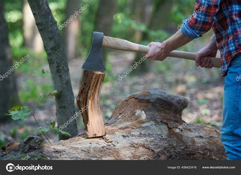 Man Cutting Trees With Axe