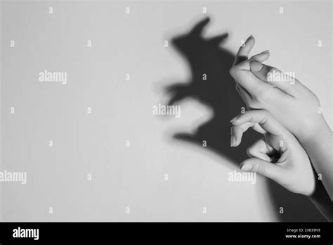Shadow Puppet Woman Making Hand Gesture Like Rabbit On Light
