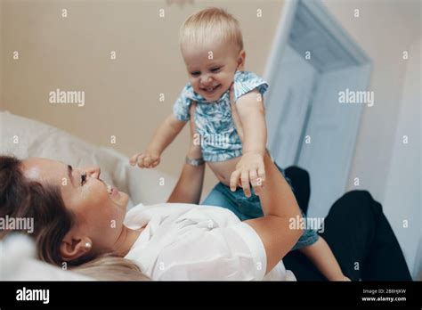 Young Mother Having Fun Laughing Playing Funny Active Games With Cute
