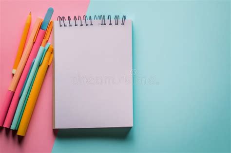 A Stack Of Colorful Notebooks And A Blank Notepad Arranged Neatly On A