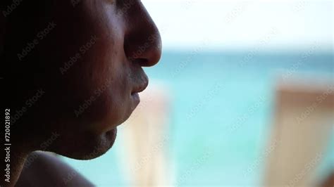 Young Happy Man Eats Sandwich With Cheese Sausage And Ketchup On