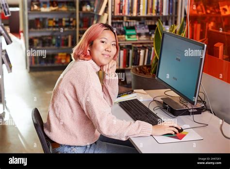 Female Babe Using Computer In Library Stock Photo Alamy